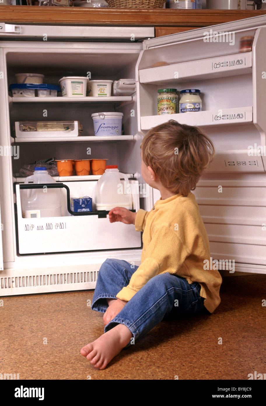 Toddler exploring a fridge Stock Photo - Alamy