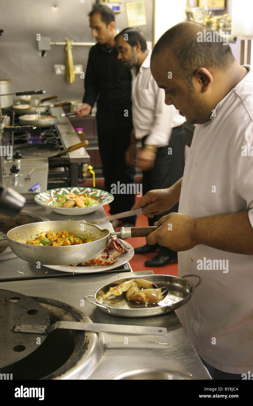 Chefs cooking in kitchen Stock Photo - Alamy