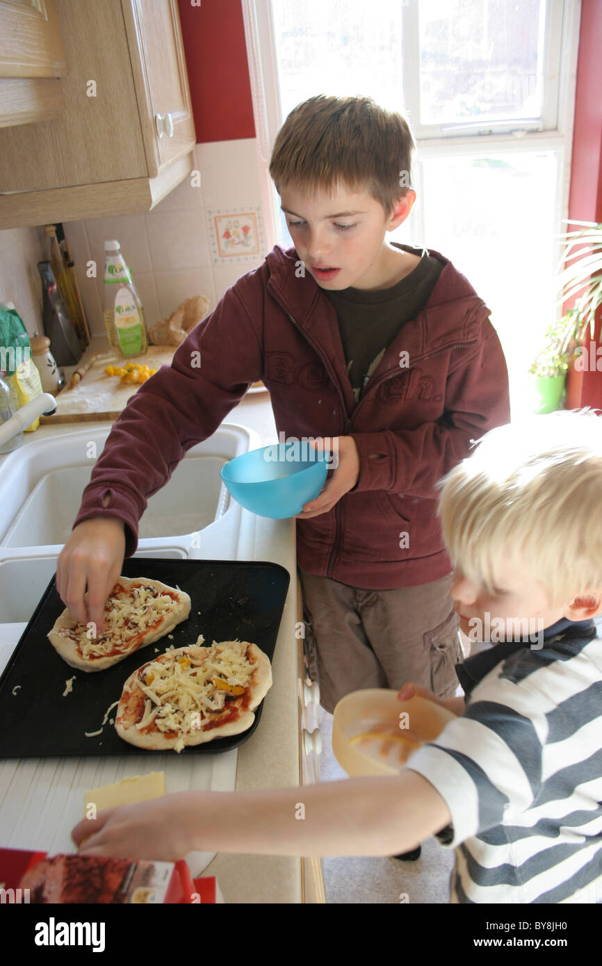 Children cooking pizza in kitchen Stock Photo - Alamy