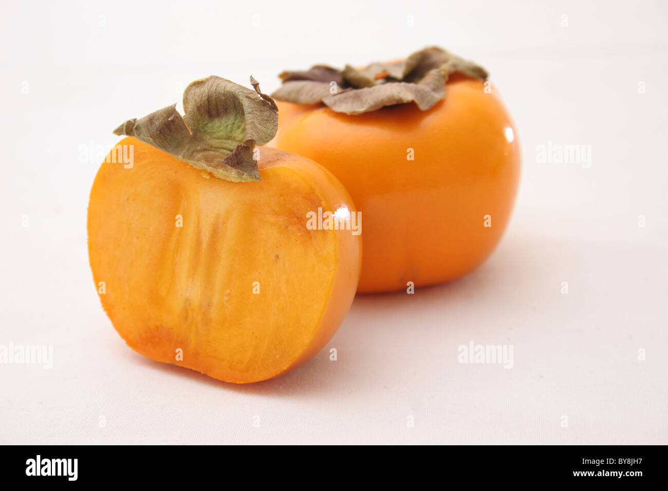 Sharon fruit on white back ground Stock Photo - Alamy