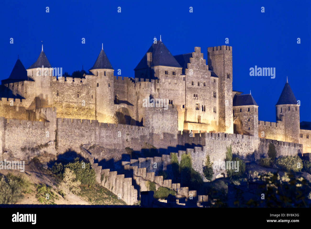Carcassonne, France - walls of the medieval city at dusk Stock Photo ...