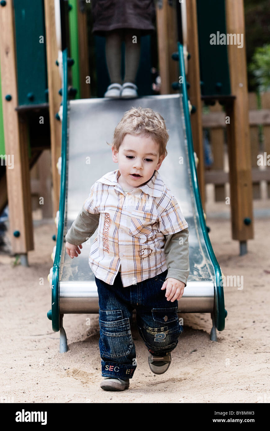 Preschool boy after a slide, running, smiling, portrait Stock Photo - Alamy