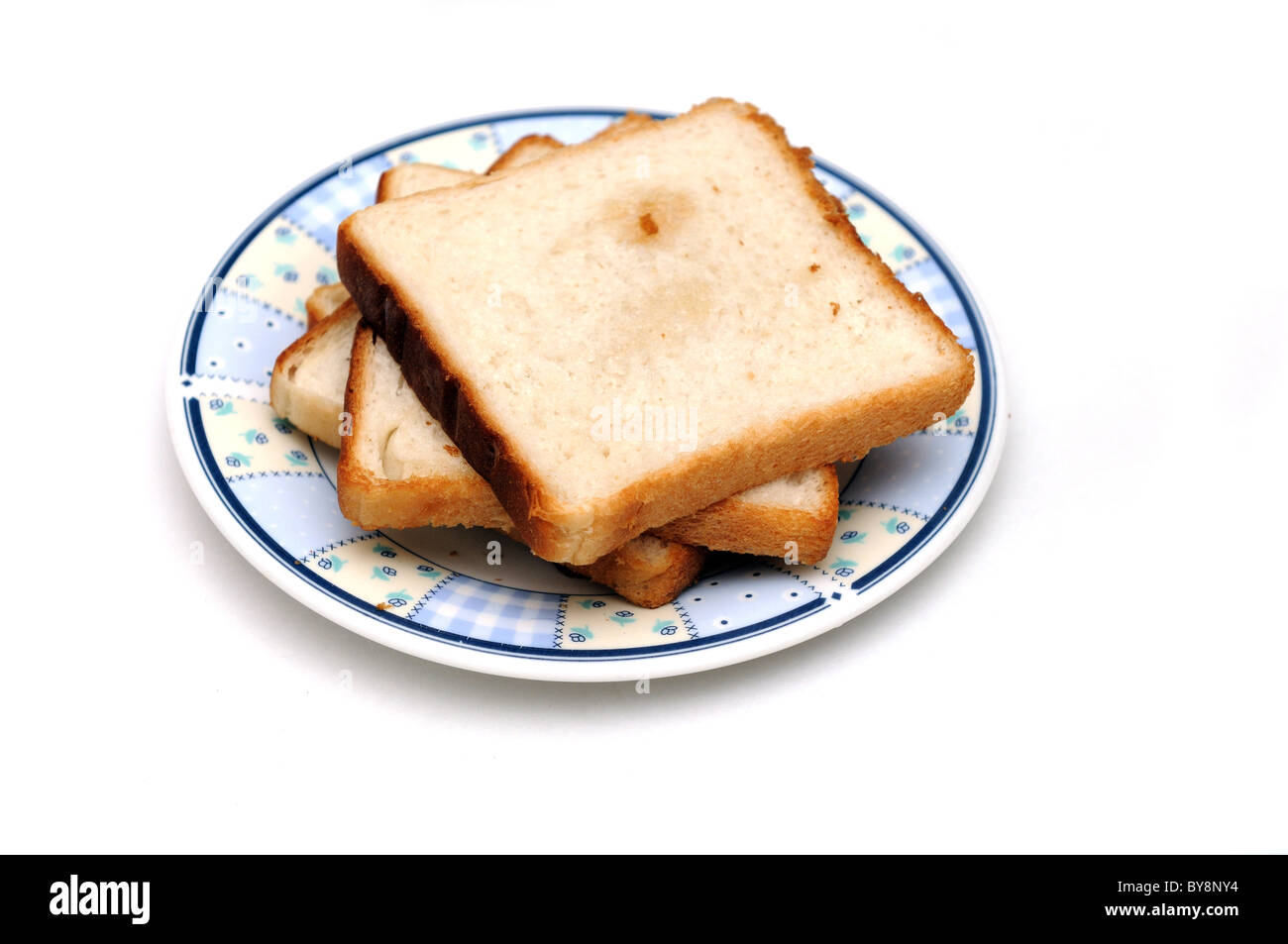 Bread toast on plate isolated against a plain background Stock Photo ...