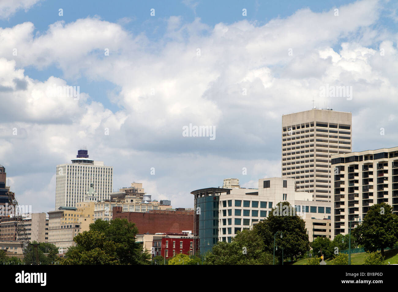Skyline view of the tops of office buildings rise above the treetops in ...