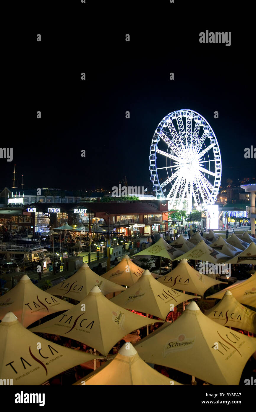 Wheel of Excellence lit up over restaurant canopies in Cape Town Stock ...