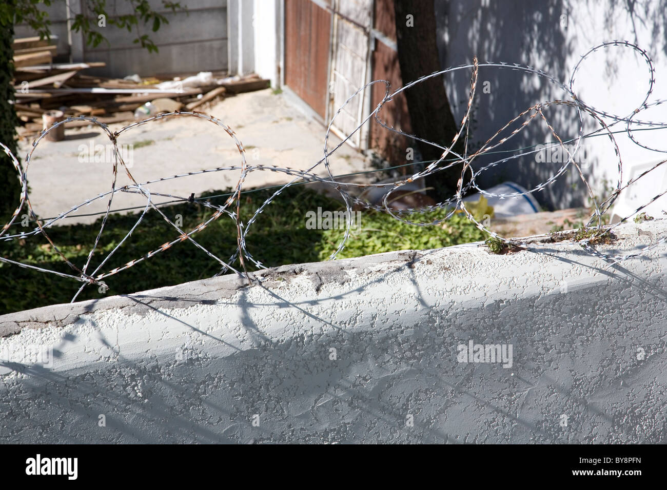 High wall barbed wire fence hi-res stock photography and images - Alamy