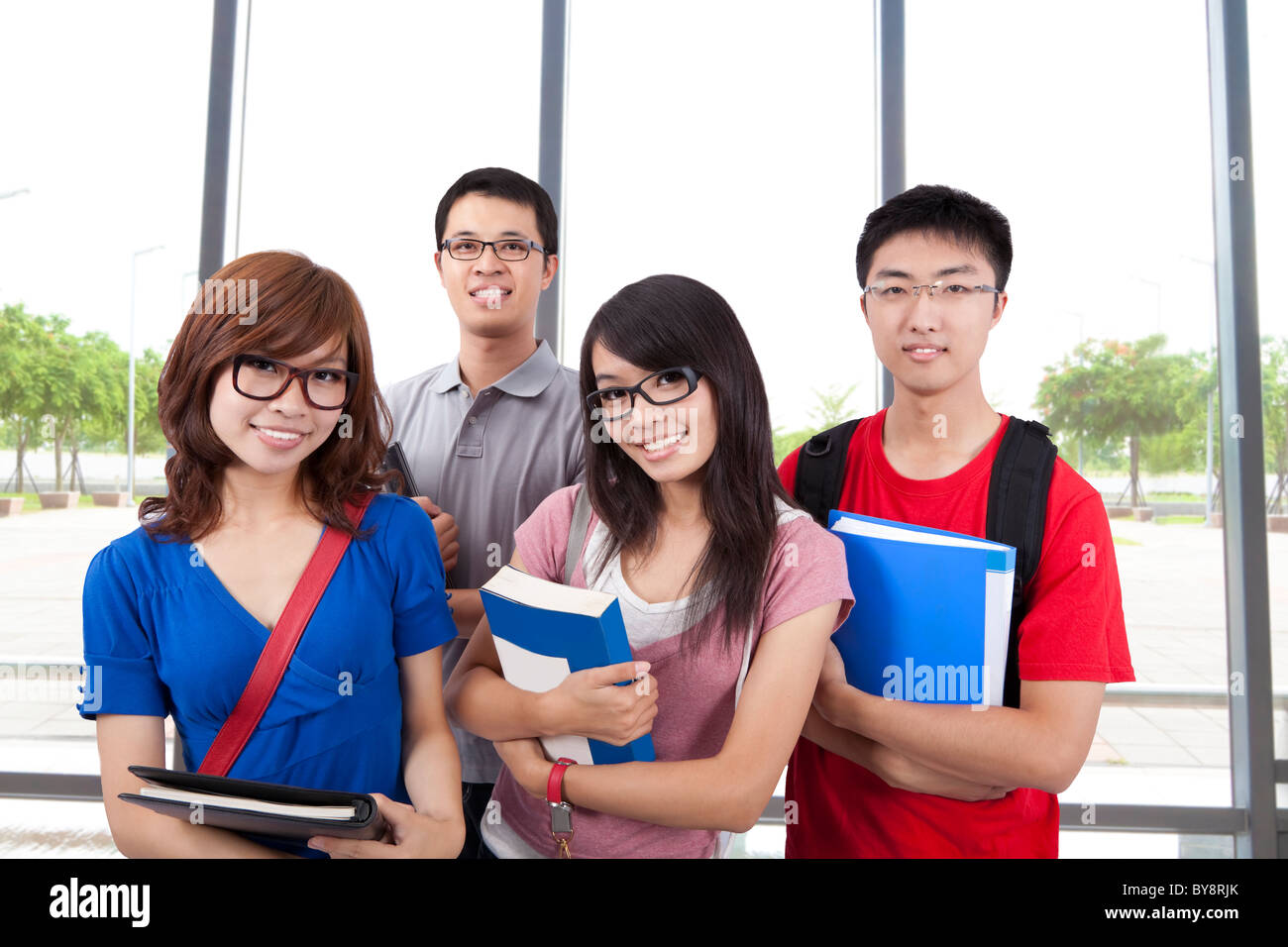 Young smiling students stand in the classroom Stock Photo - Alamy