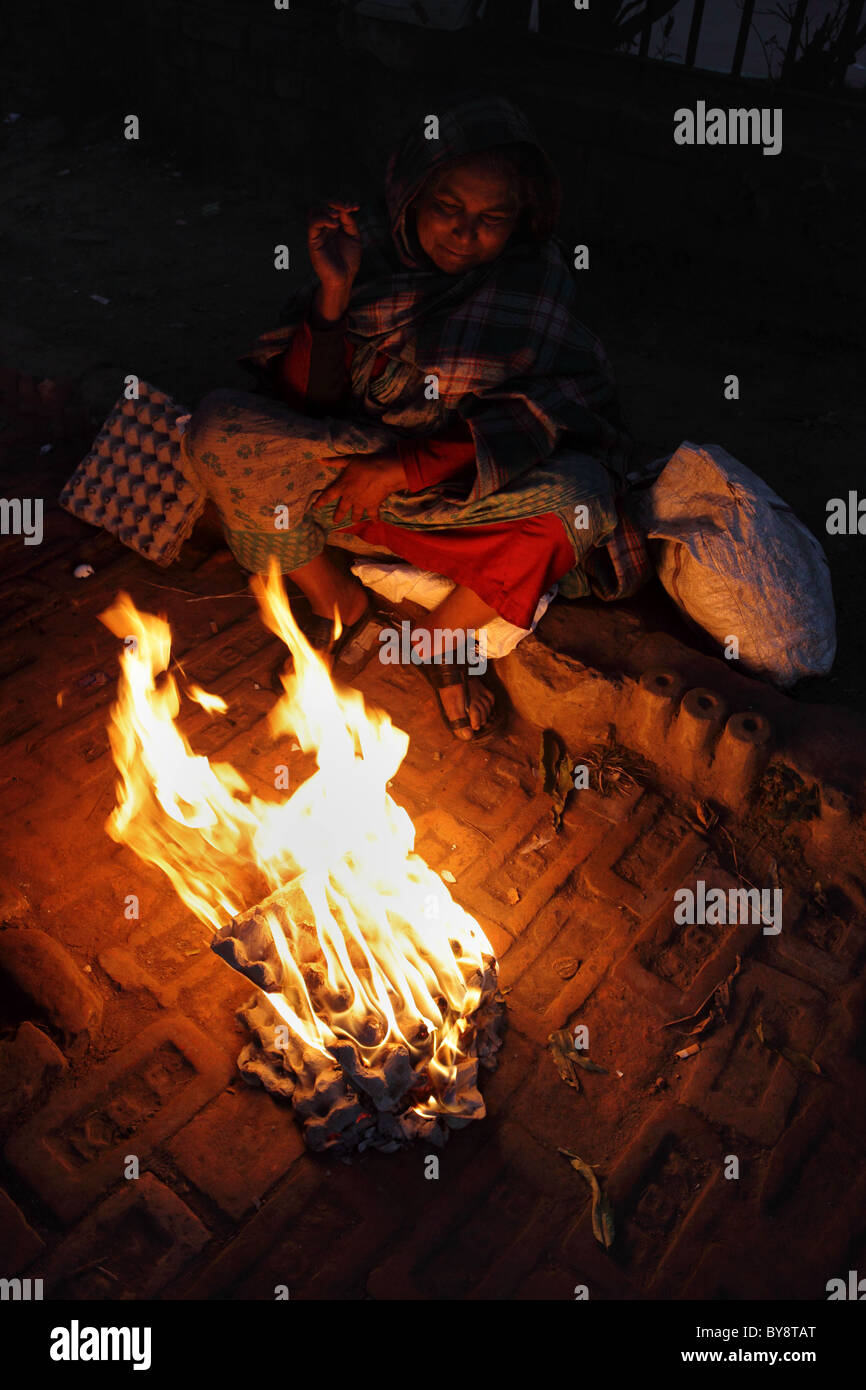 Woman making a fire in Kolakta Calcutta India Asia Stock Photo - Alamy