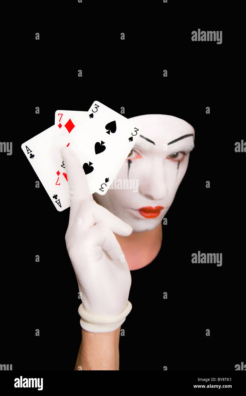 Portrait of mime with playing cards on black background Stock Photo - Alamy