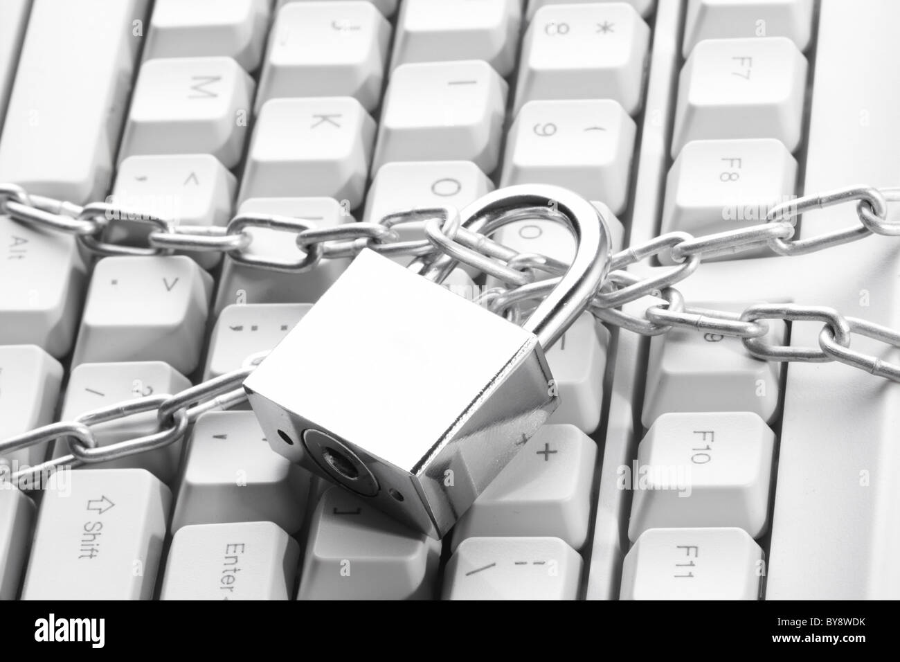 Computer keyboard secured with chain and padlock Stock Photo - Alamy