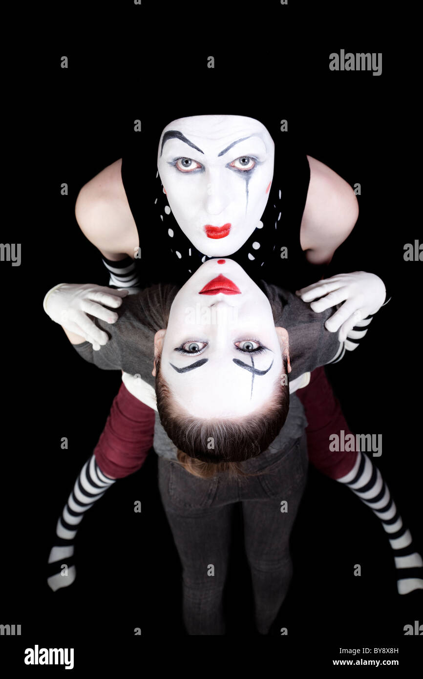Portrait of two mimes on black background Stock Photo - Alamy