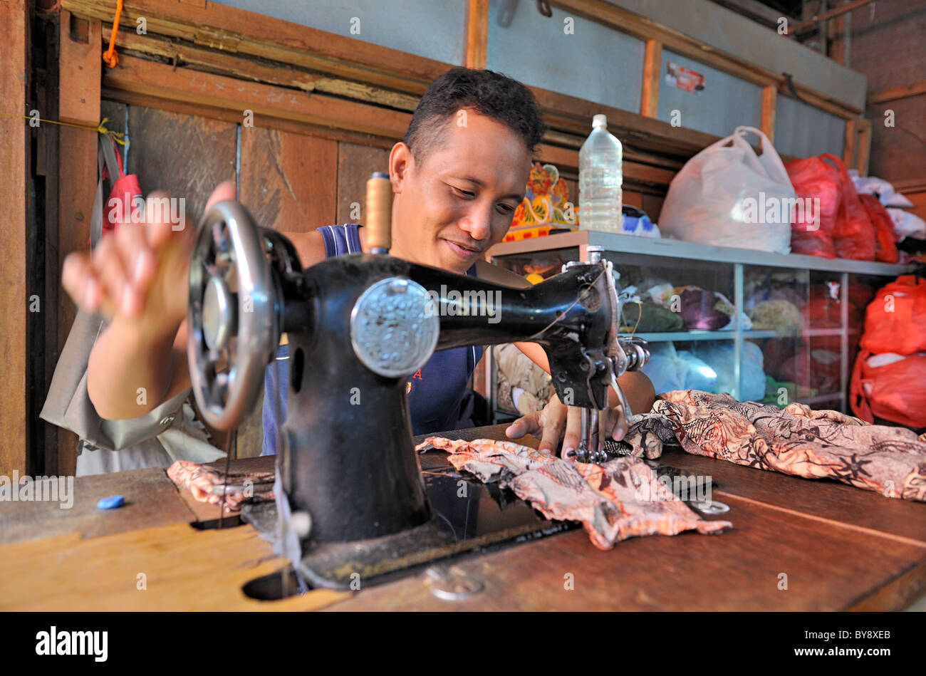 Balinese Tailor at work on his sewing machine Stock Photo - Alamy