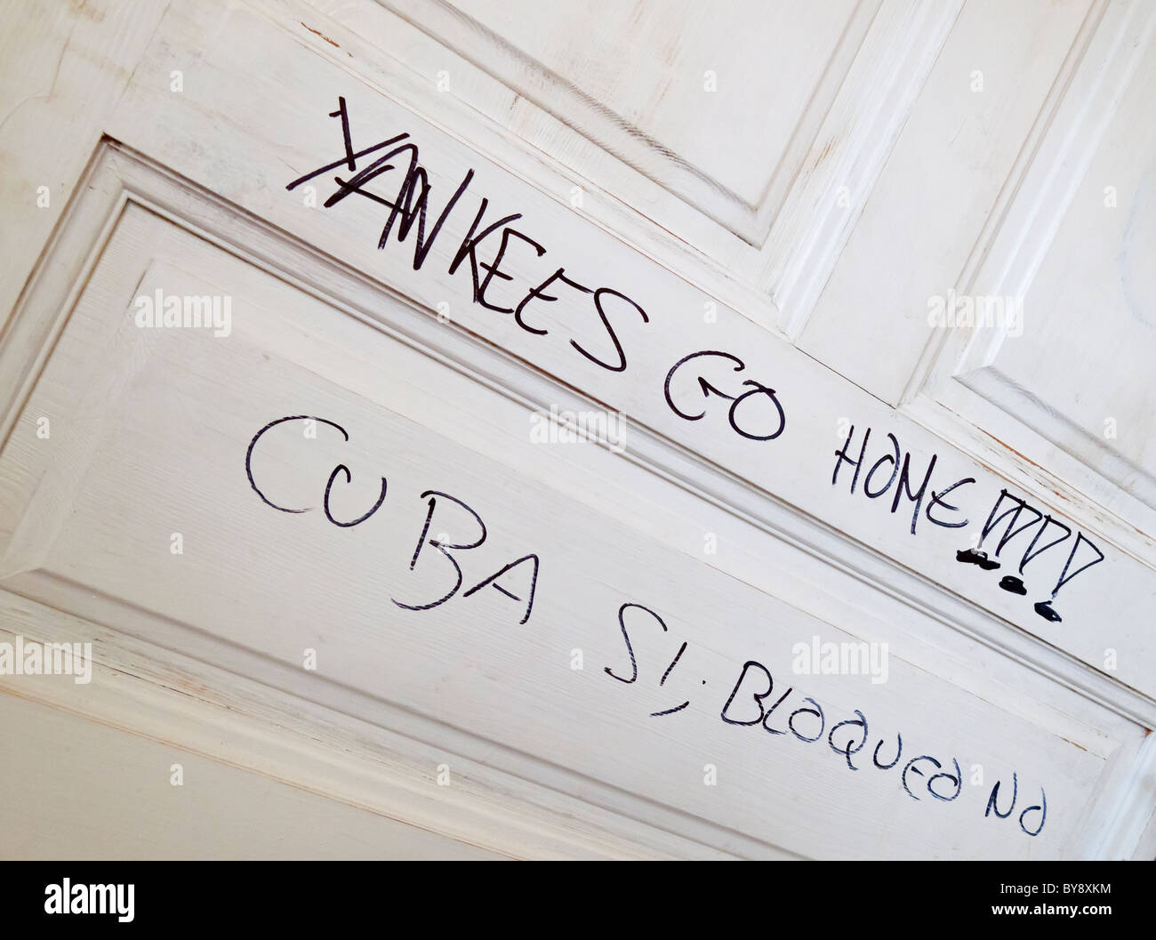 Anti American graffiti scrawled on a door with Yankees Go Home Cuba SI ...