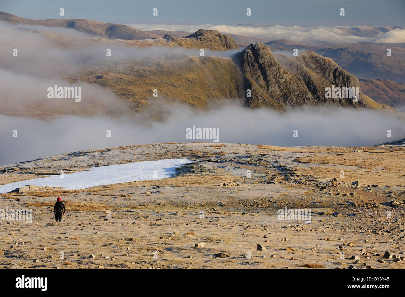 Walker and dog on Esk Hause in the English Lake District with the ...