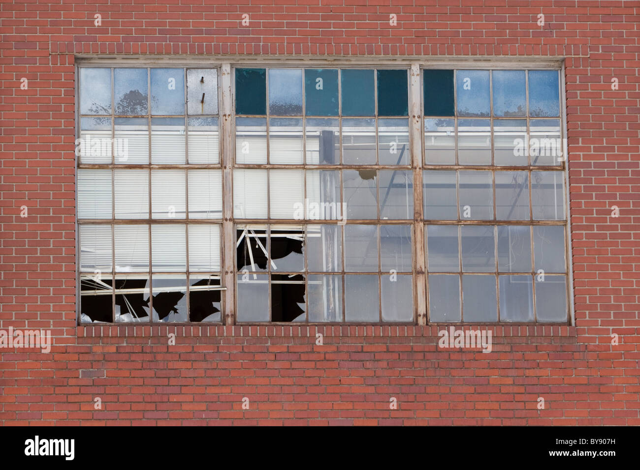 Abandoned old manufacturing plant - broken windows and boarded up Stock ...