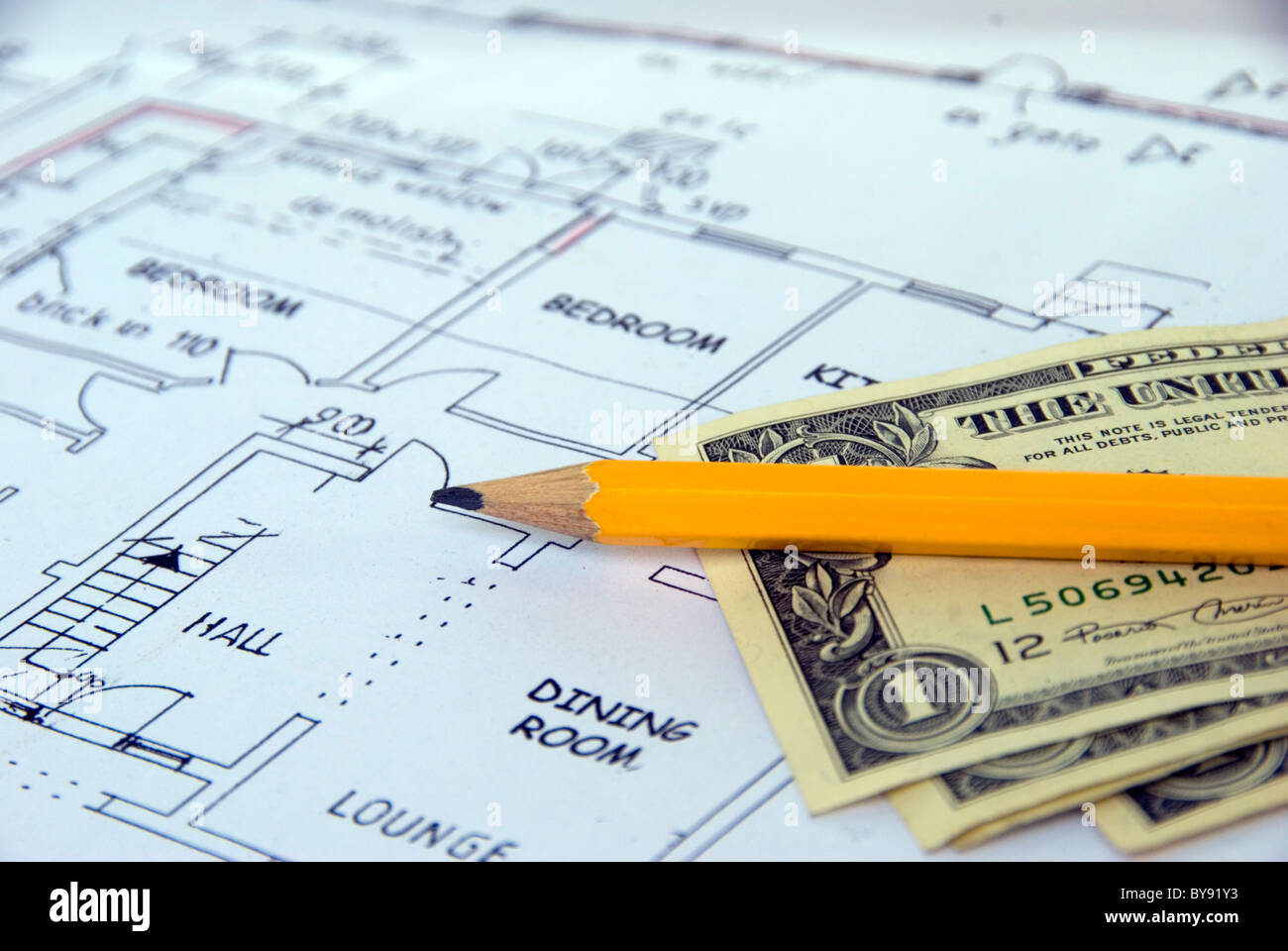 dollar bills on building plans Stock Photo - Alamy
