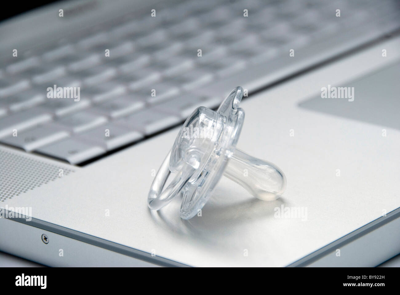 baby's dummy lying on keyboard of computer Stock Photo - Alamy