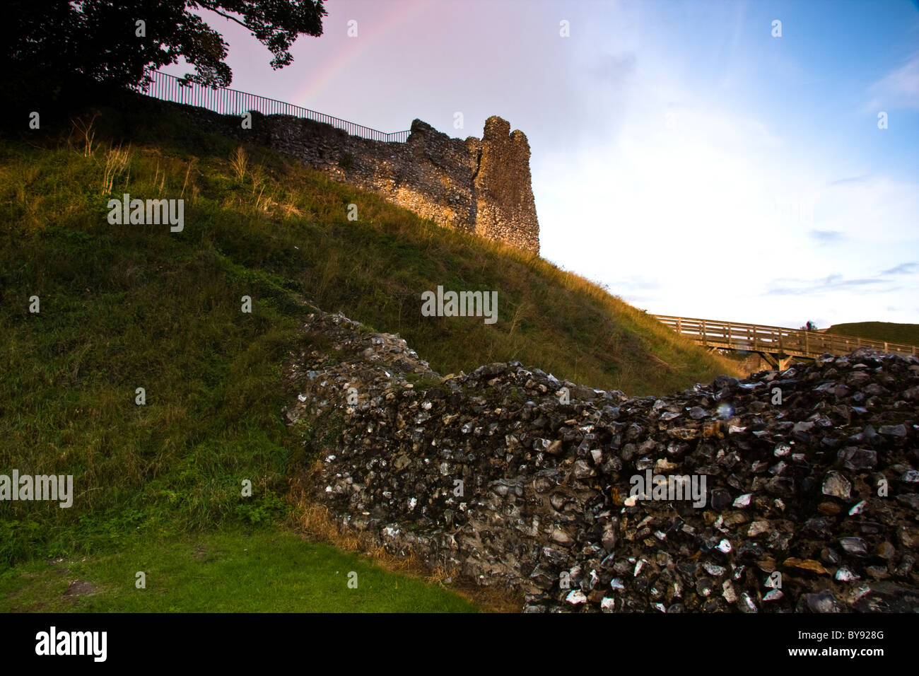 The castle ruins at Castle Acre in Norfolk with rainbow appearing over ...