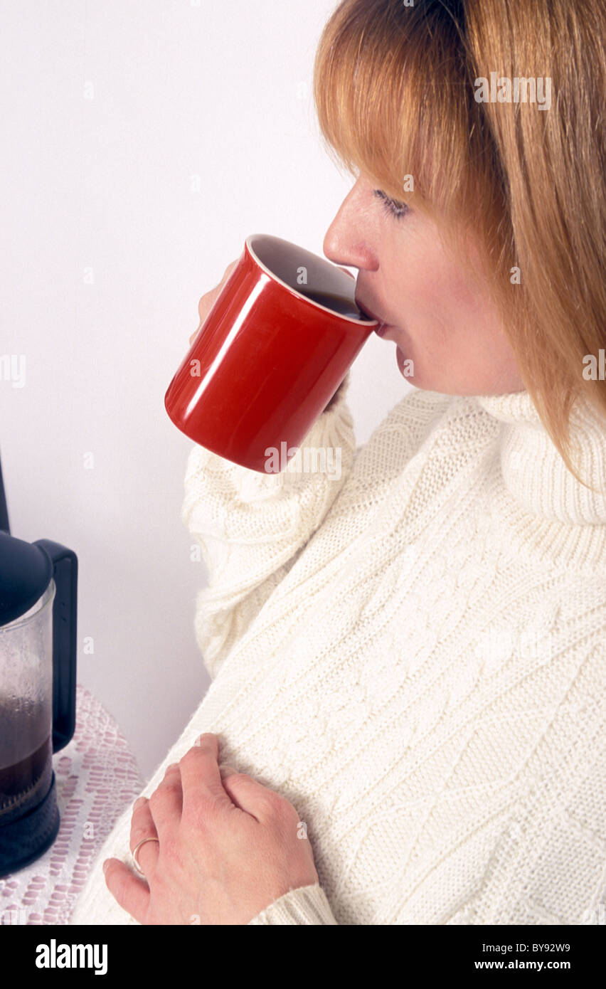 pregnant woman drinking pot of coffee Stock Photo - Alamy