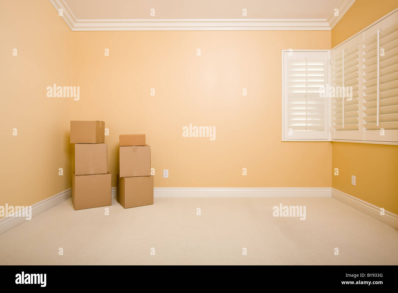 Moving Boxes in Empty Room with Copy Space on Blank Wall Stock Photo ...