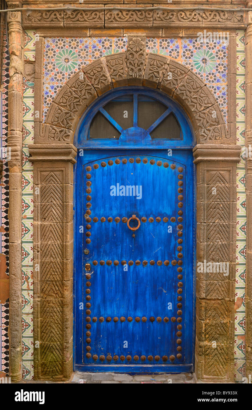 Blue door in Essaouira Medina with ornate stonework and Zellige ...
