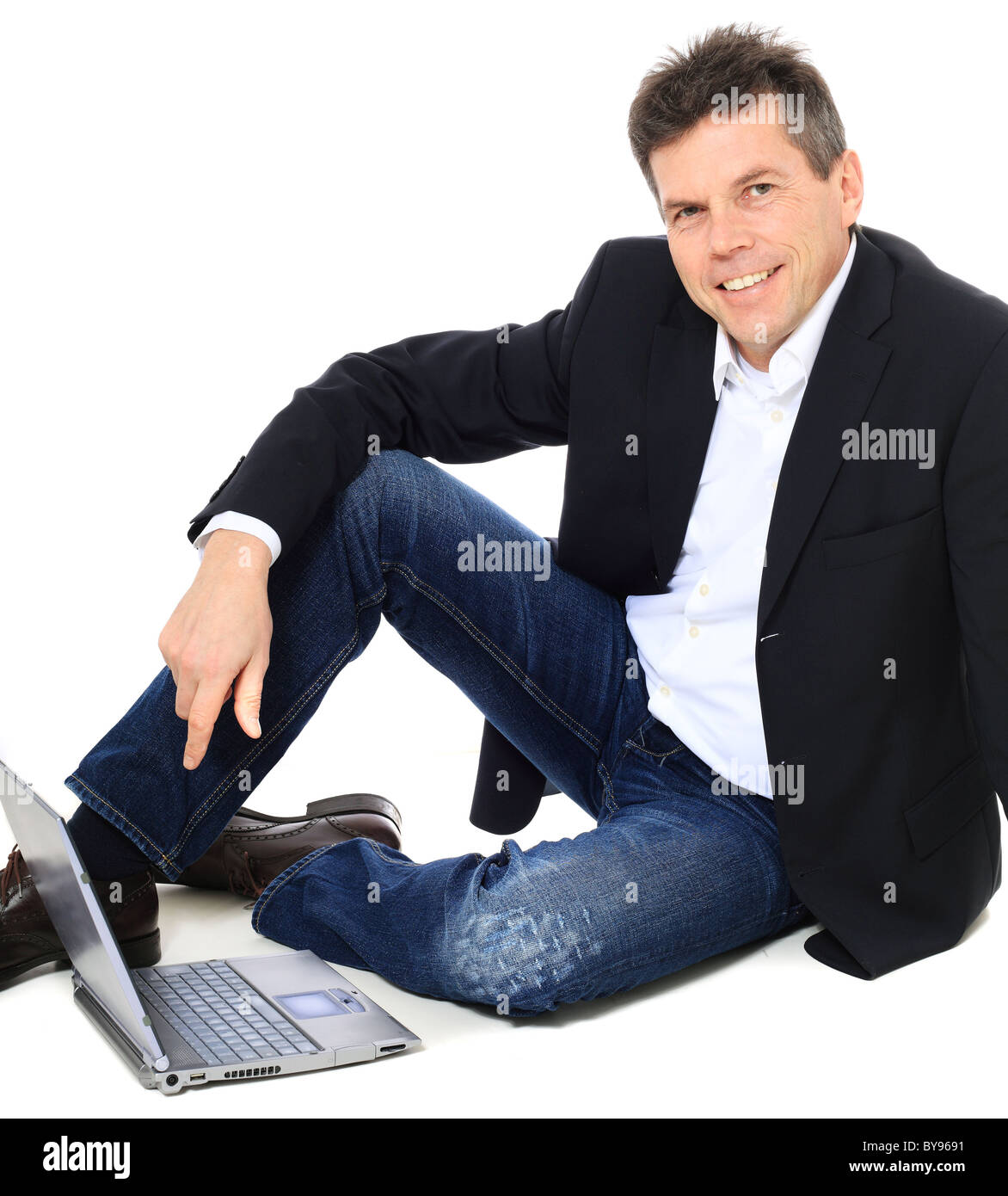 Attractive middle-aged man using notebook computer. All on white ...
