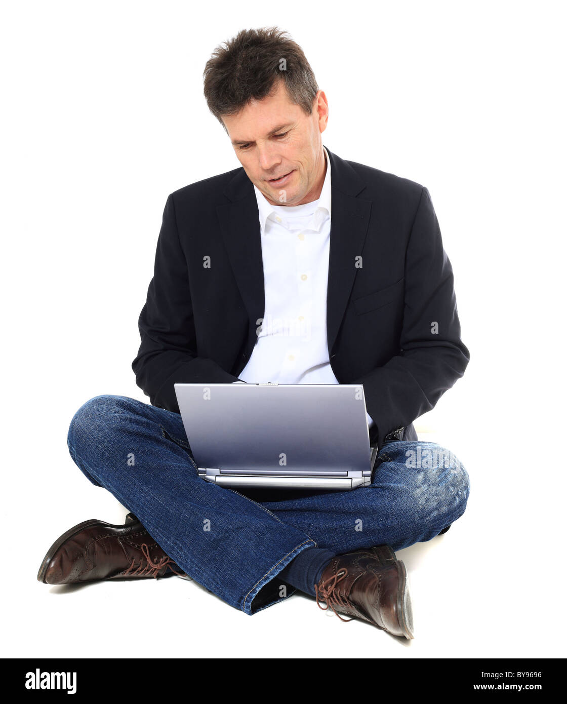 Attractive middle-aged man using notebook computer. All on white ...