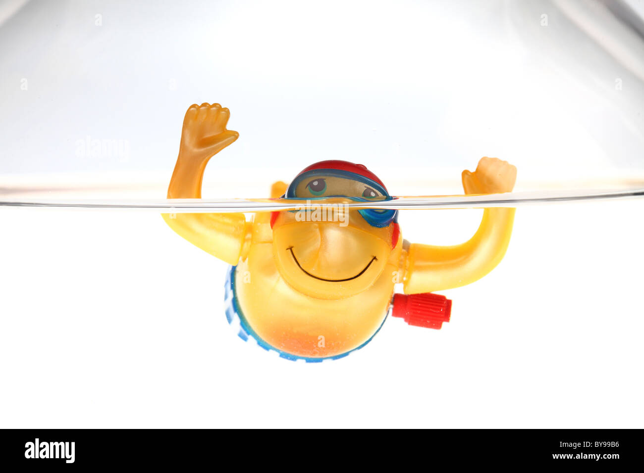 Swimmer, alone, in a fish bowl. Wind up toy Stock Photo - Alamy