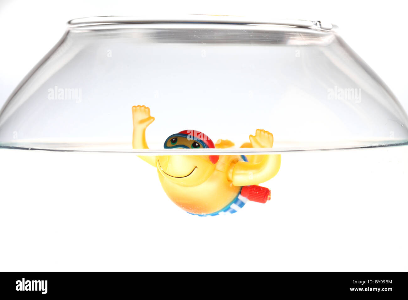 Swimmer, alone, in a fish bowl. Wind up toy Stock Photo - Alamy