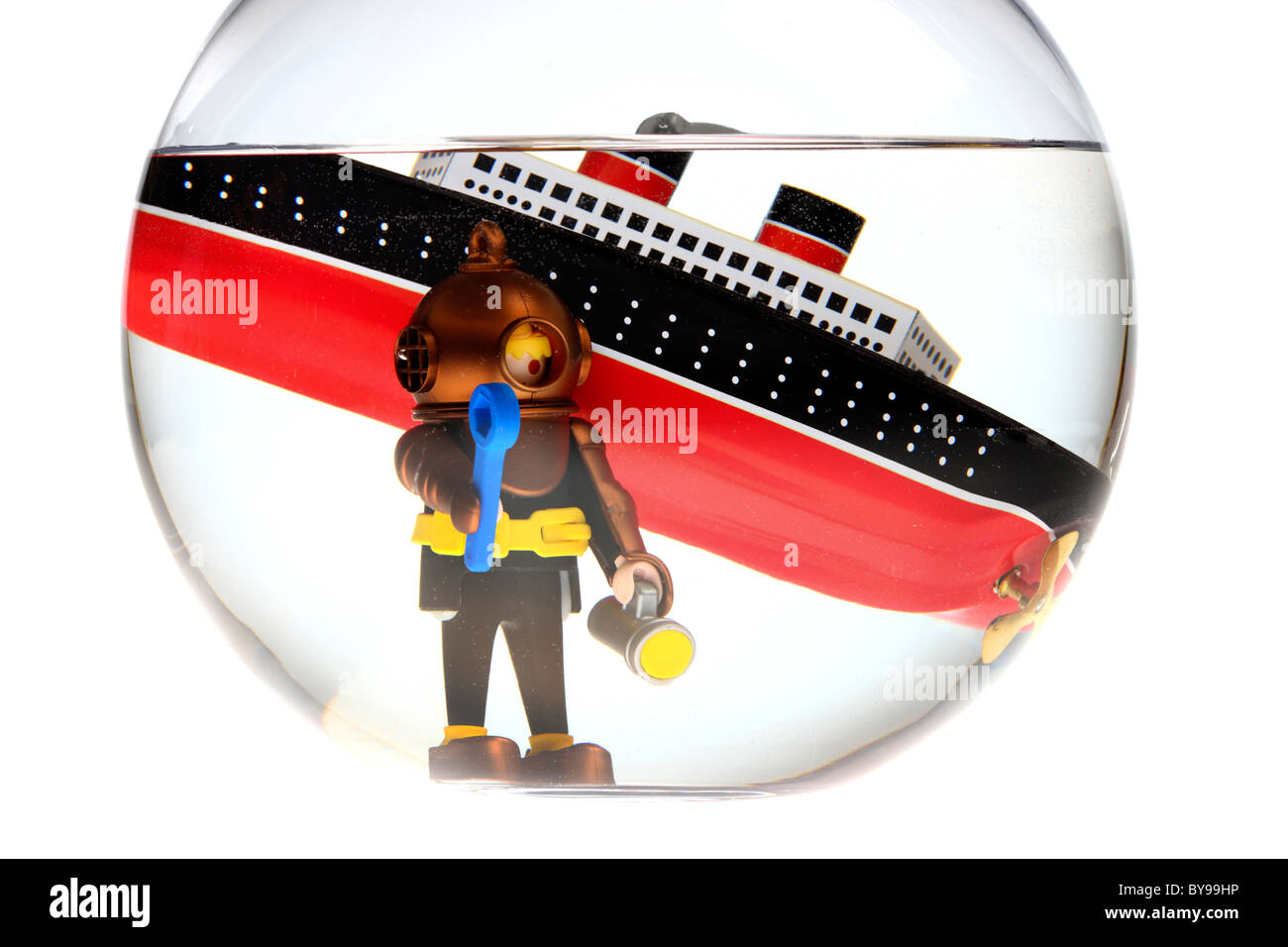 Sunken cruise ship in a fish bowl. Diver with tools. Mechanic tin toy ...