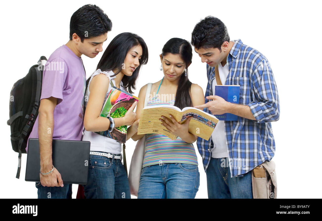 College students looking at a book Stock Photo - Alamy