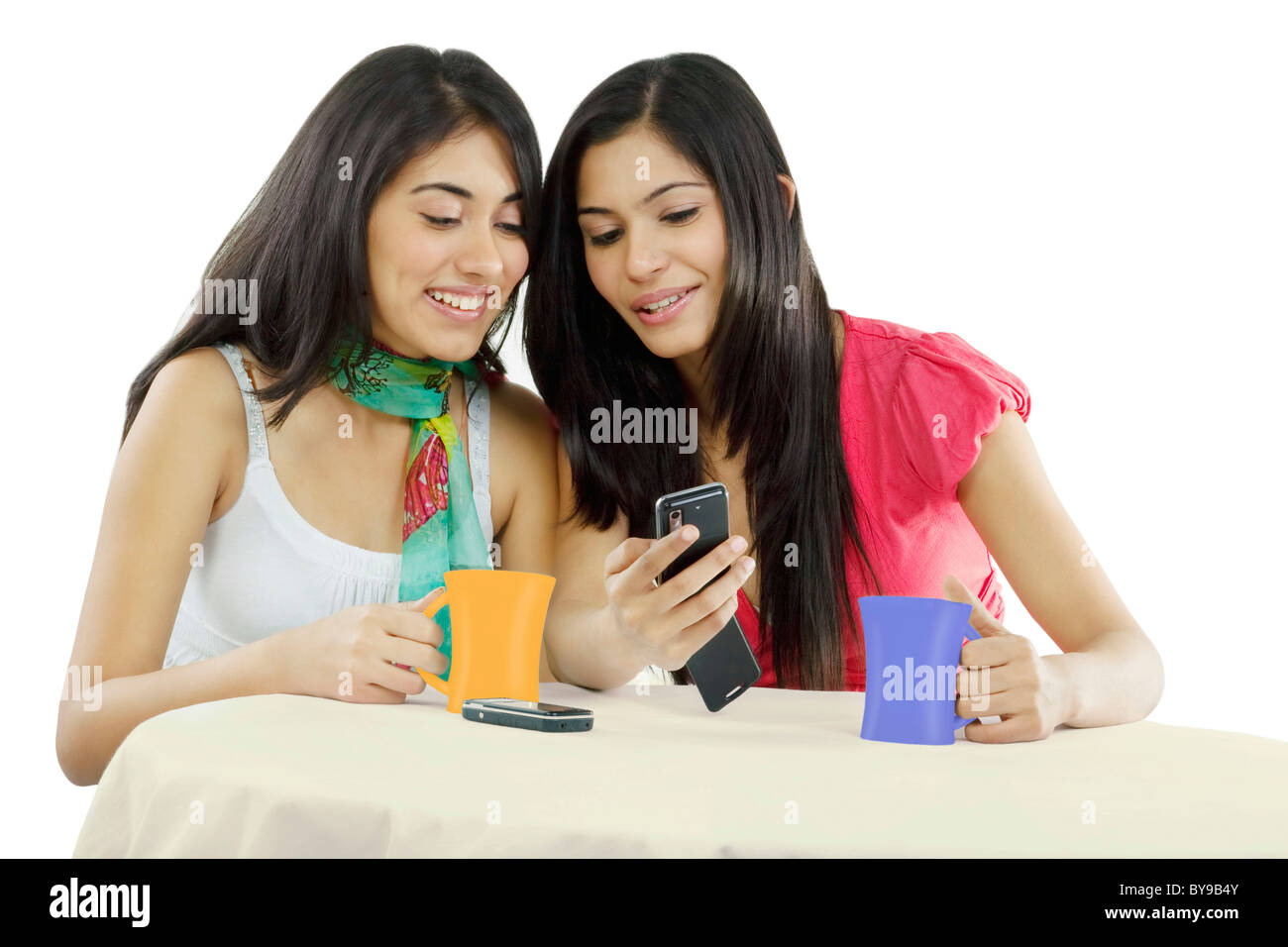 Two friends looking at a mobile phone Stock Photo - Alamy