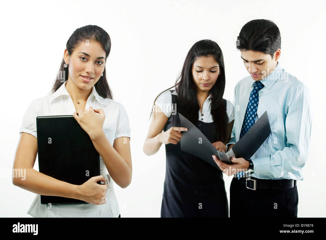 Businesspeople looking at a file Stock Photo - Alamy