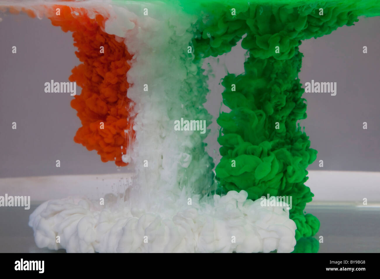 Different colours mixing in water Stock Photo - Alamy