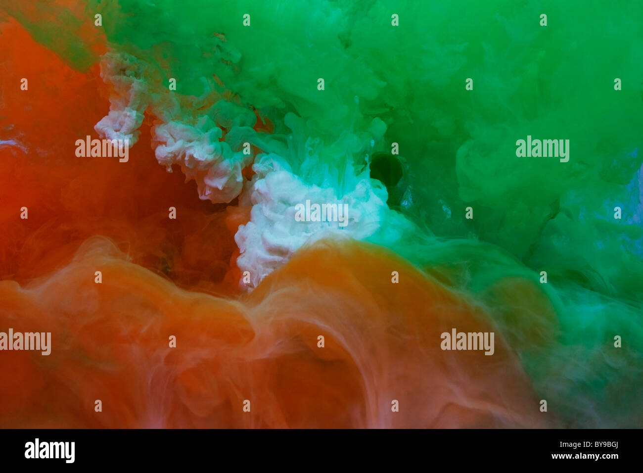 Different colours mixing in water Stock Photo - Alamy