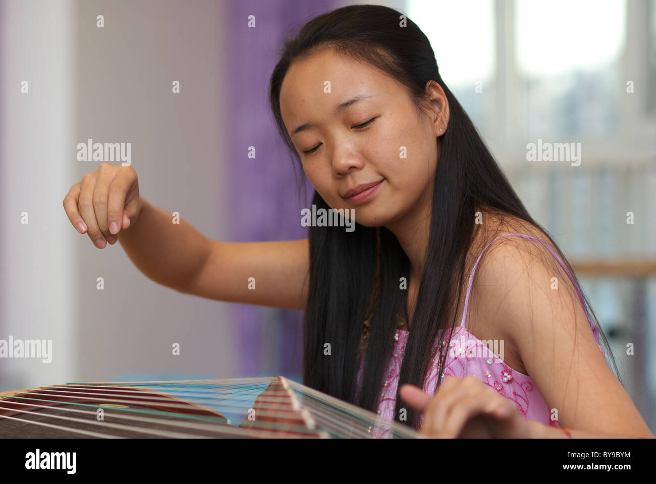 Chinese girl playing traditional musical instrument hi-res stock ...