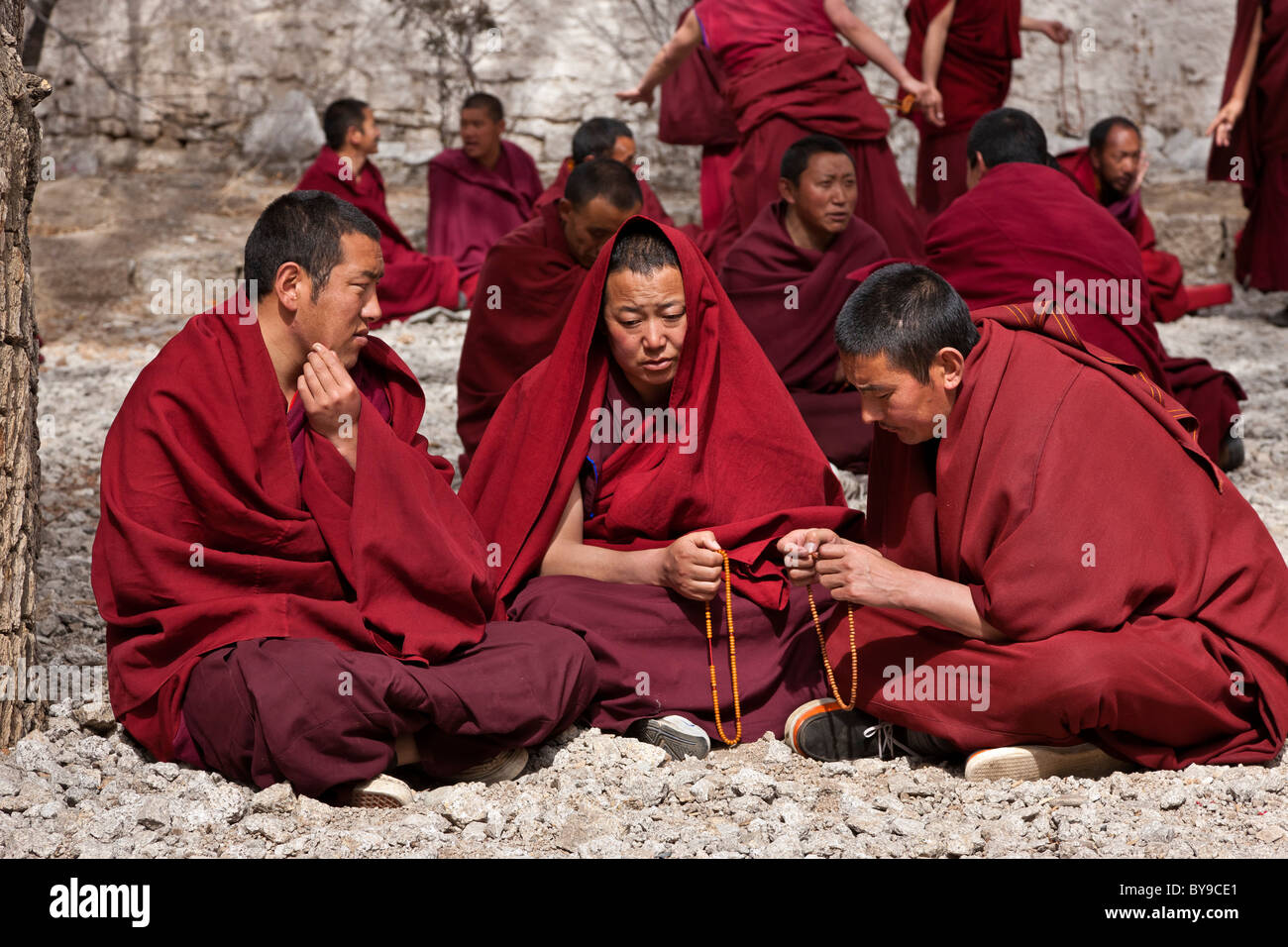 Monks with prayer beads in the Debating Courtyard at Sera Monastery ...