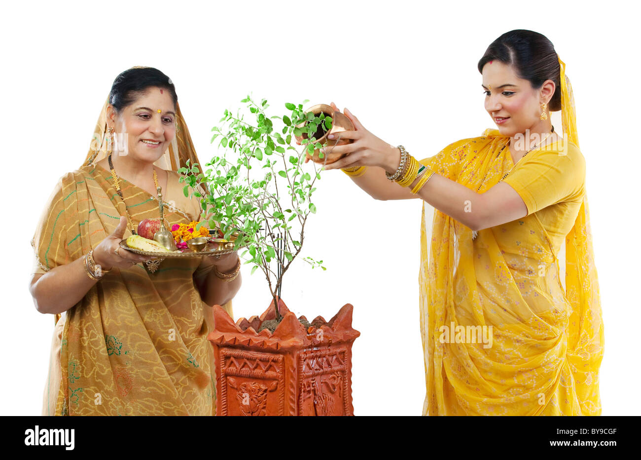 Mother and daughter making an offering Stock Photo - Alamy
