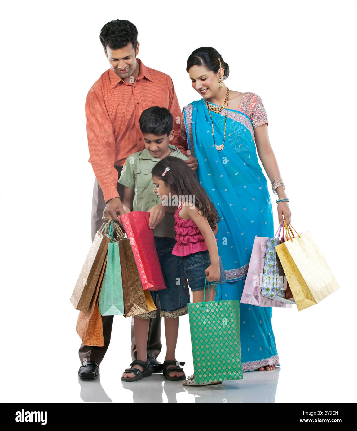 Family with shopping bags Stock Photo - Alamy