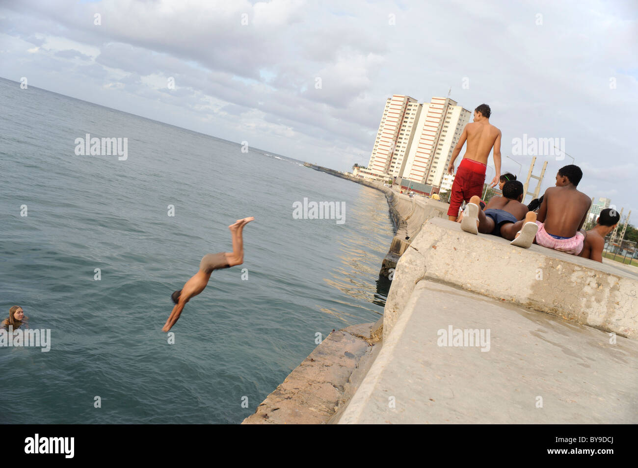 Cuban kids playing and diving in the sea from the Malecon in Havana ...
