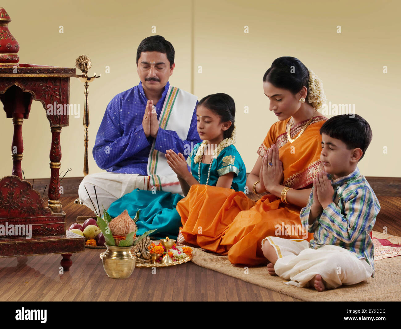 South Indian family praying Stock Photo - Alamy