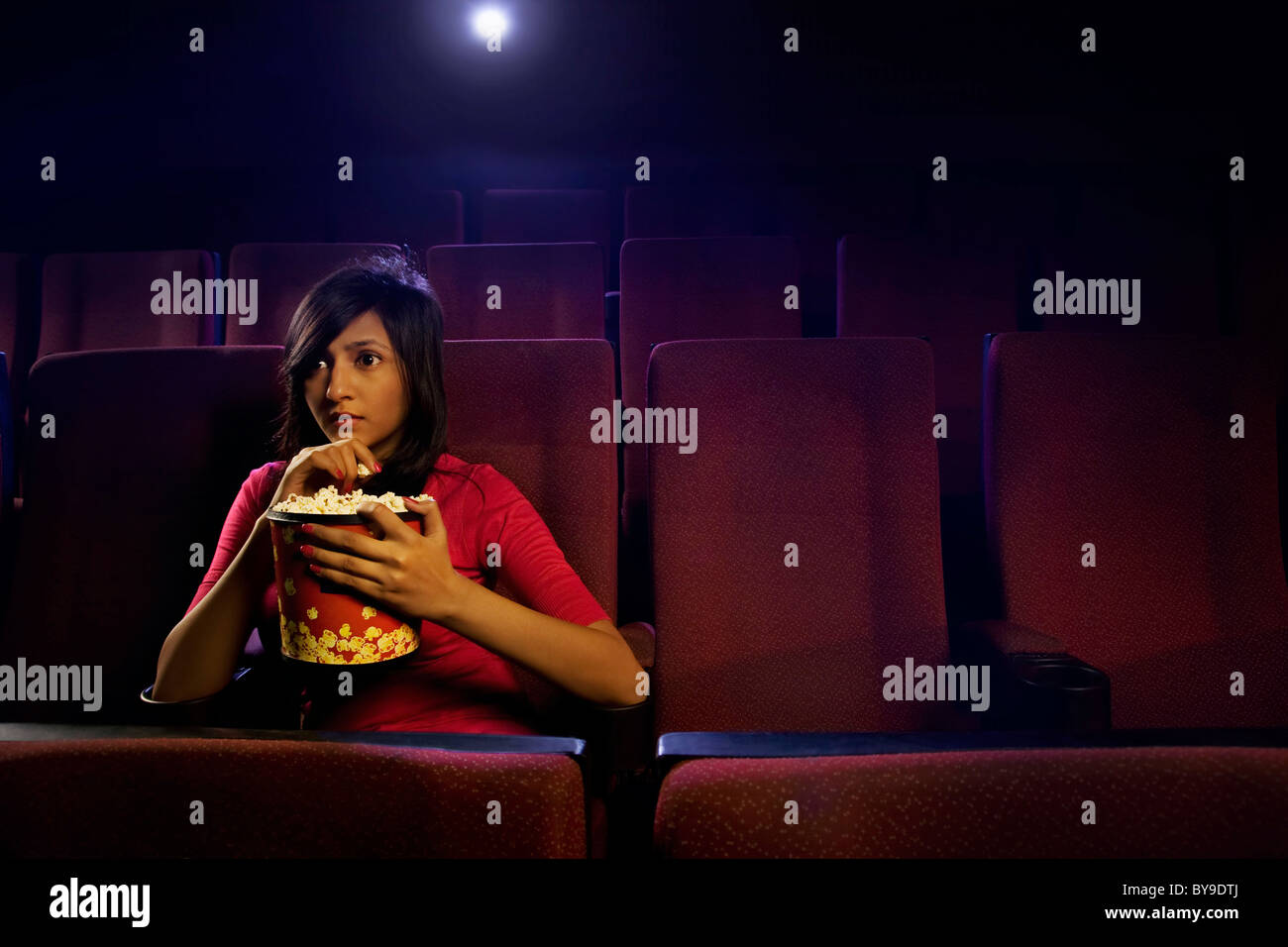 Girl watching a movie Stock Photo - Alamy