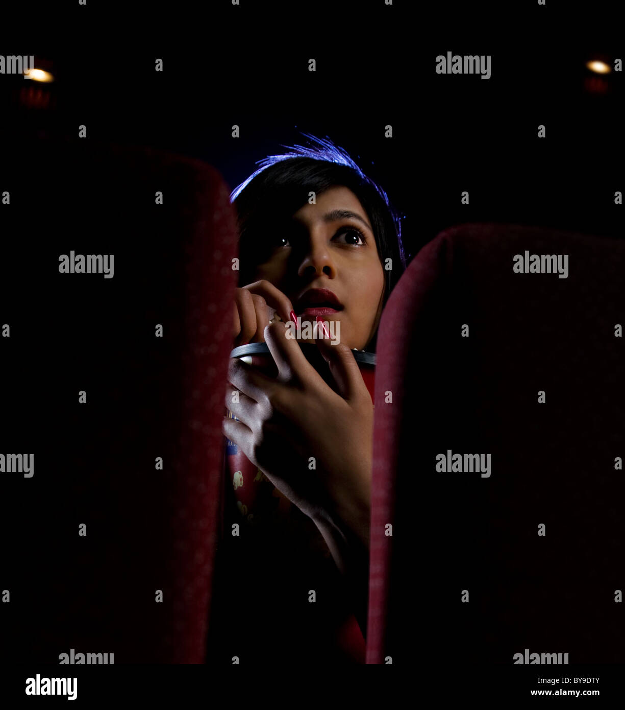 Girl watching a movie Stock Photo - Alamy