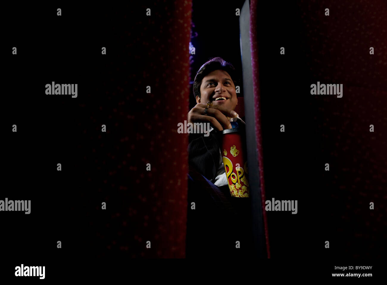 Man watching a movie Stock Photo - Alamy