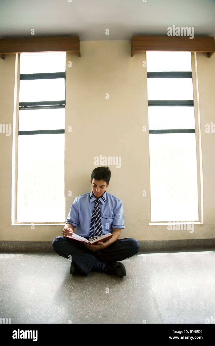 Boy reading in a classroom Stock Photo - Alamy