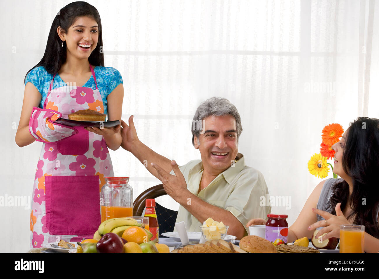 Daughter serving her family Stock Photo - Alamy