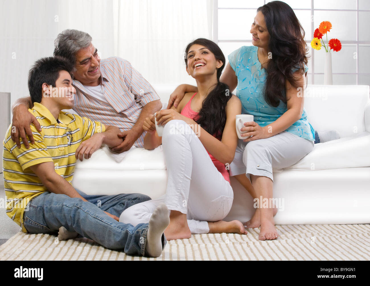 Family sitting together in the living room Stock Photo - Alamy