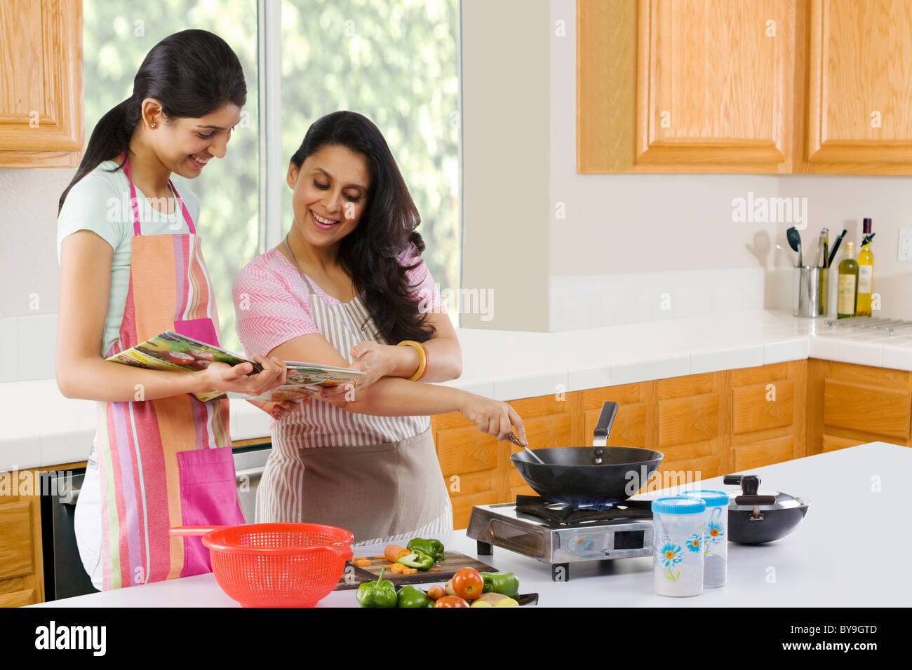Mother and daughter cooking in the kitchen Stock Photo - Alamy