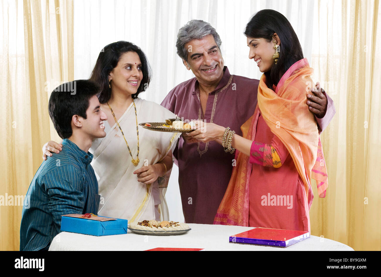 Girl offering sweets during Rakhi Stock Photo - Alamy