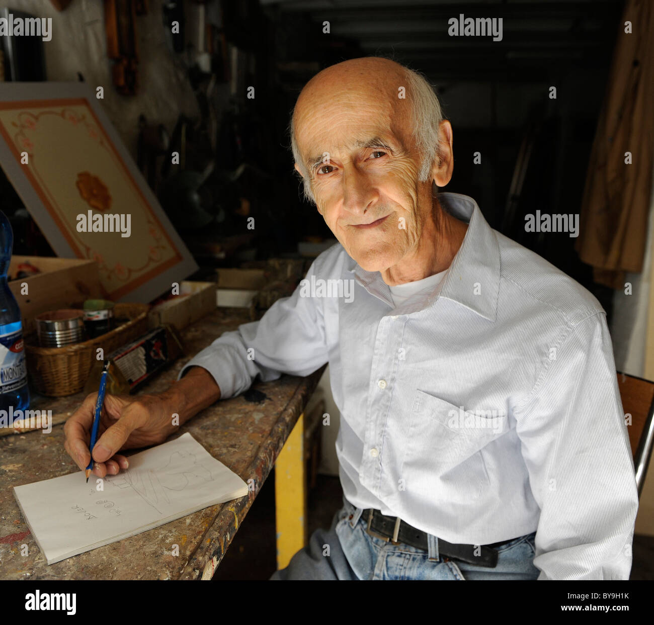 an old artist painter in his rustic garage studio in Cortona, Tuscany ...